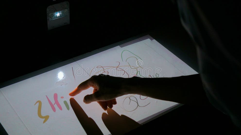 Woman Using Interactive Touchscreen Projector Display for Drawing Stock ...