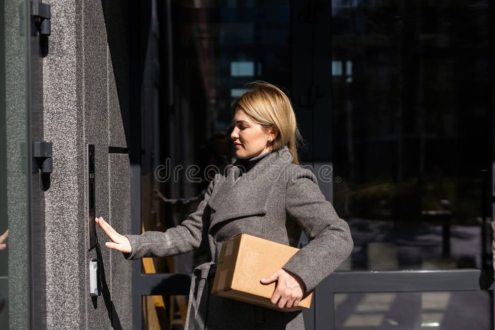 Woman Using Intercom at Building Entrance. Stock Photo - Image of home ...