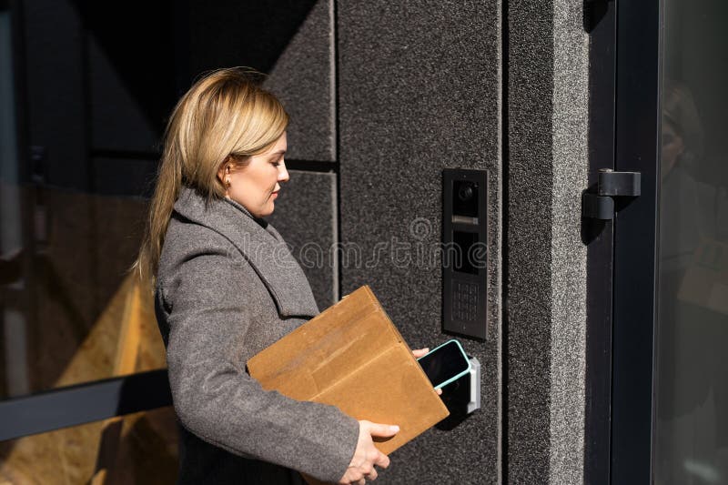 Woman Using Intercom at Building Entrance. Stock Image - Image of hand ...