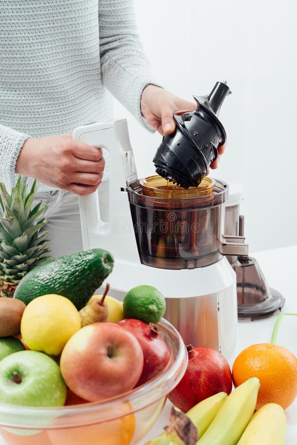 Woman Using a Juice Extractor Stock Photo - Image of appliance, kitchen ...