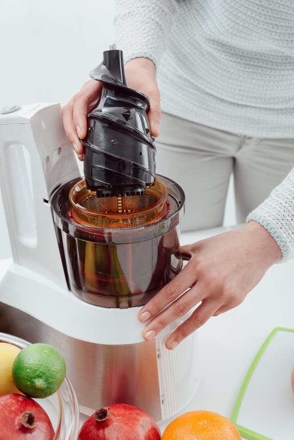 Woman Using a Juice Extractor Stock Image - Image of beverage, healthy ...