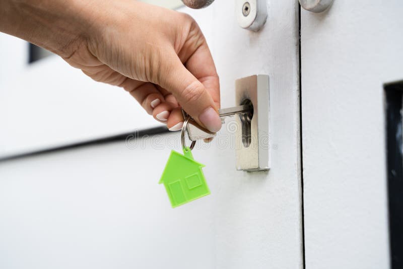 Woman Using Key To Open Door Stock Image - Image of modern, entrance ...