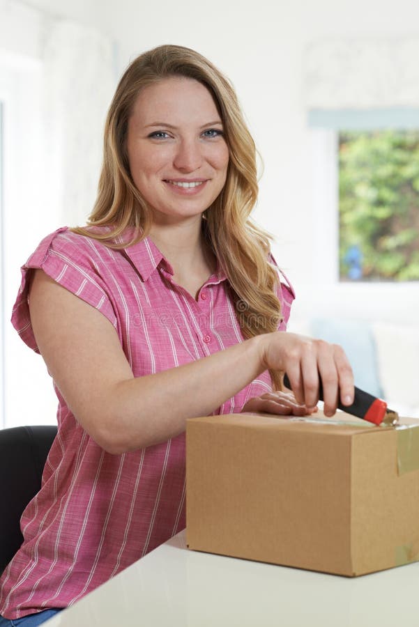 Woman Using Knife To Open Package at Home Stock Image - Image of ...