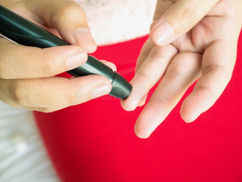 Woman Using Lancelet on Finger, Diabetes Test Stock Photo - Image of ...