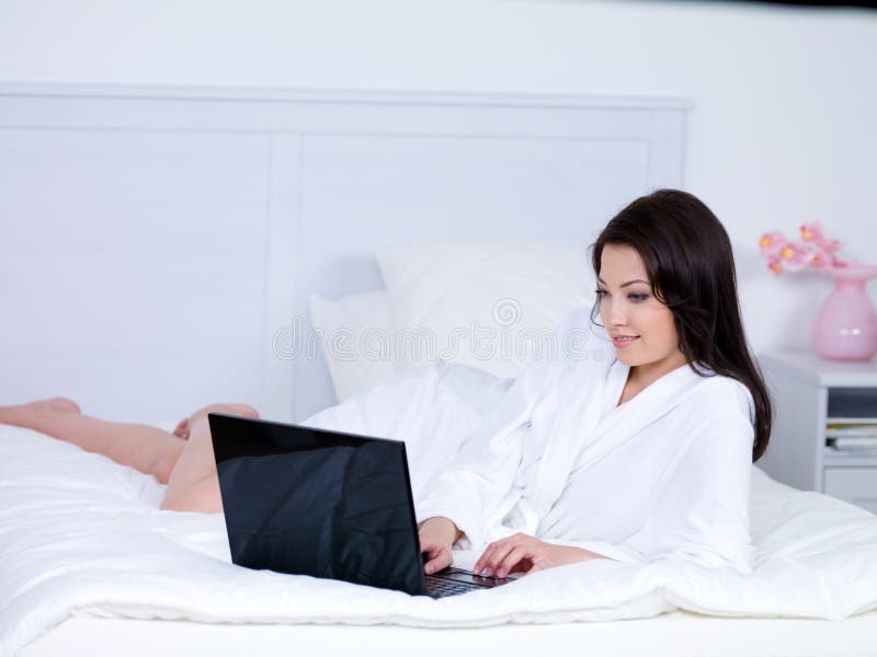 Woman Using Laptop on a Bed Stock Photo - Image of technology, typing ...