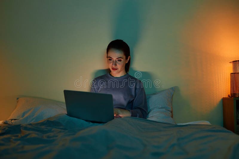 Woman Using Laptop in Bed at Night Lit by Screen Stock Image - Image of ...