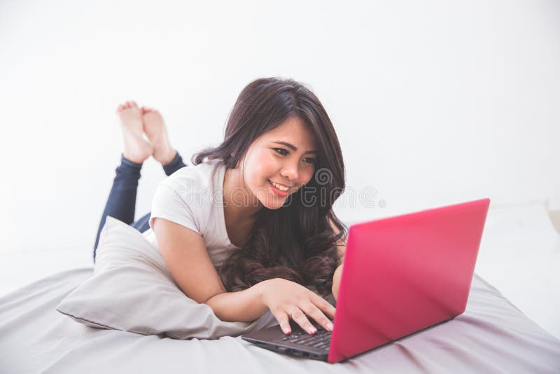 Woman Using Laptop on the Bed Stock Image - Image of pillow, holding ...