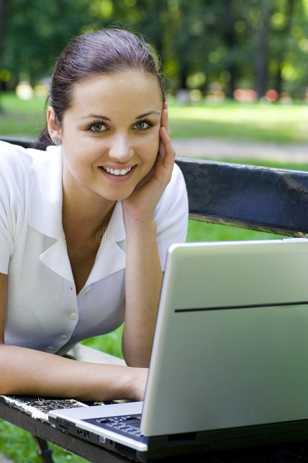 Woman Using Laptop on Bench Outdoors Stock Image - Image of smile ...