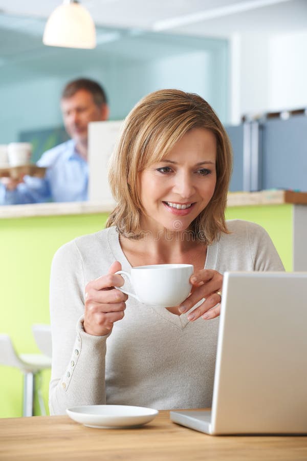 Woman Using Laptop in Cafe stock image. Image of urban - 62922561