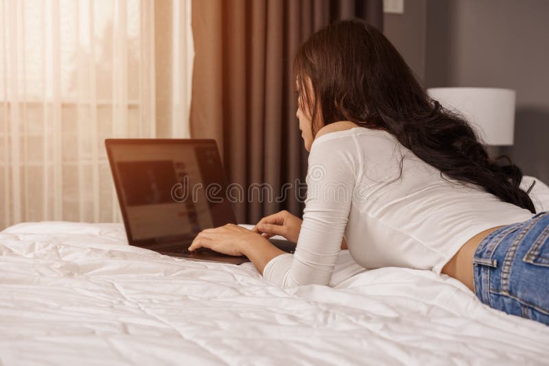 Woman Using Laptop Computer on Bed Stock Image - Image of lying ...