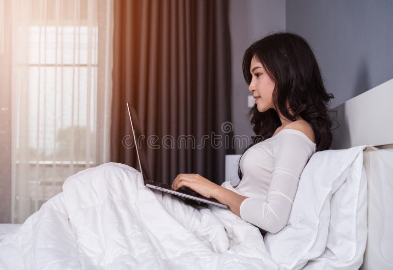 Woman Using Laptop Computer on Bed Stock Photo - Image of attractive ...