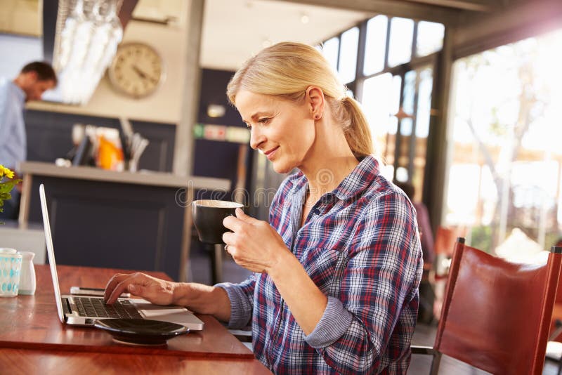 Woman Using Laptop Computer at a Coffee Shop Stock Image - Image of ...