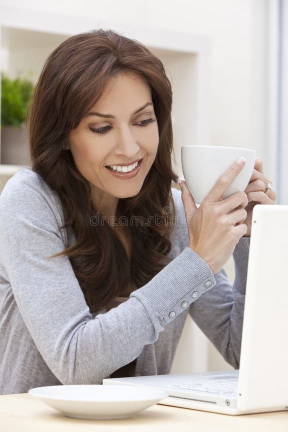 Woman Using Laptop Computer Drinking Tea or Coffee Stock Image - Image ...