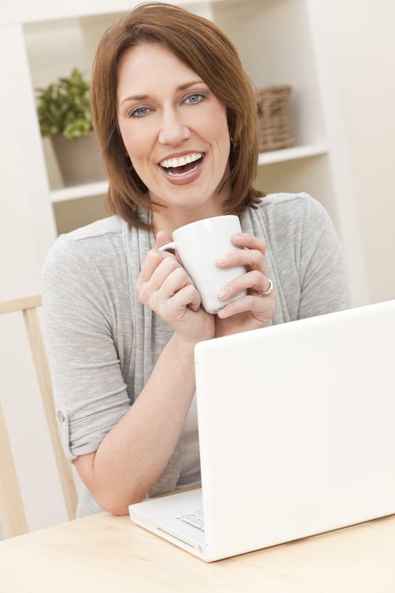Woman Using Laptop Computer Drinking Tea Coffee Stock Photo - Image of ...