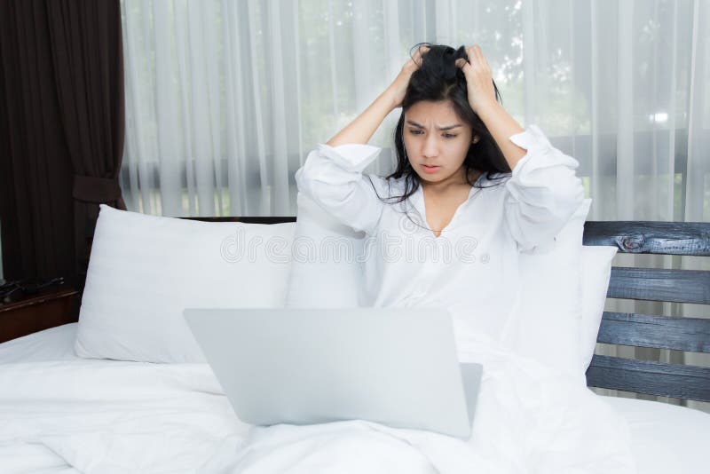 Woman Using a Laptop Computer on Her Bed Stock Image - Image of adult ...
