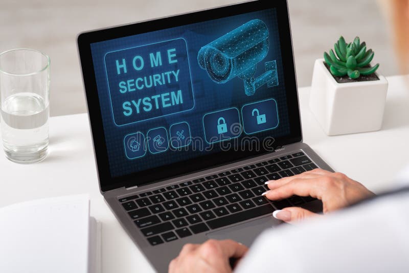 Woman Using Laptop with Home Security Application Stock Photo - Image ...