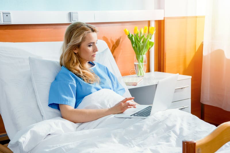 Woman Using Laptop while Lying in Hospital Bed Stock Image - Image of ...