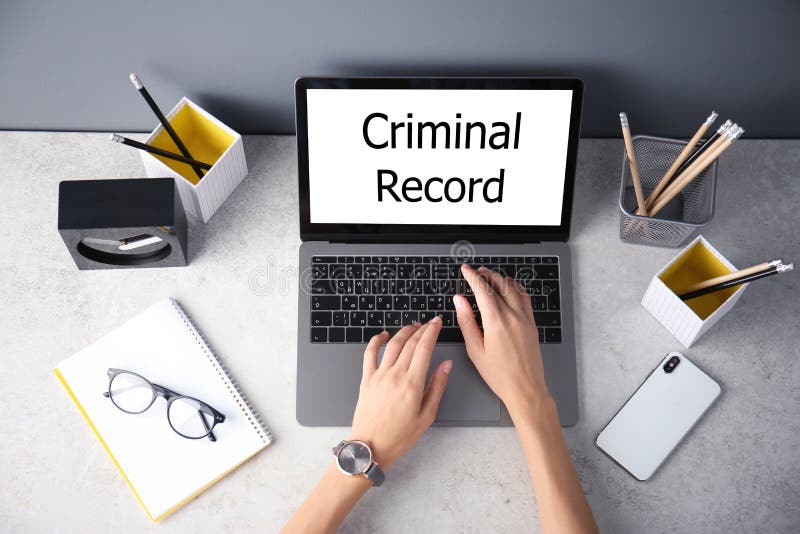 Woman Using Laptop with Words CRIMINAL RECORD at Table Stock Photo ...