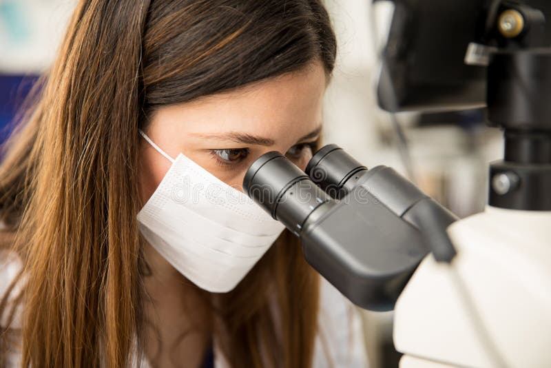 Woman Using Microscope in a Lab Stock Image - Image of mask, clinical ...