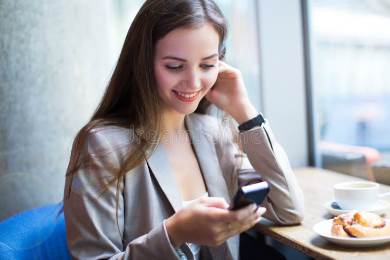 Woman Using Mobile Phone at Cafe Stock Image - Image of people ...