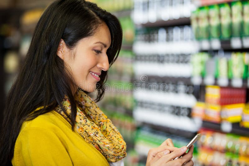 Woman Using Mobile Phone in Grocery Section Stock Photo - Image of ...