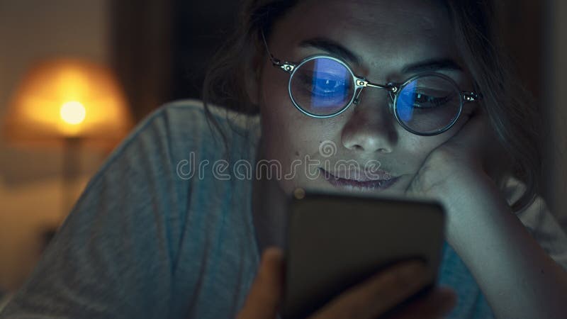 Woman Using Mobile Phone while Laying on Bed Stock Image - Image of ...