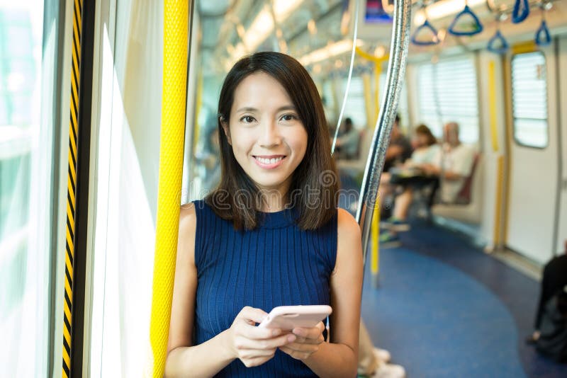 Woman Using Mobile Phone in Metro Compartment Stock Photo - Image of ...