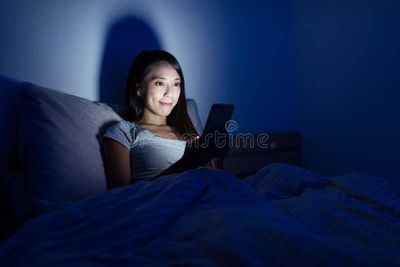 Woman Using Mobile Phone at Night on Bed Stock Image - Image of cell ...