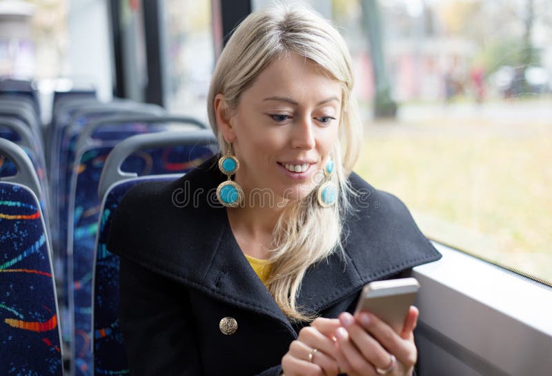 Woman Using Mobile Phone while Riding in Public Transport Stock Photo ...