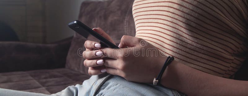 Woman Using Mobile Phone while Sitting on a Couch at Home Stock Photo ...