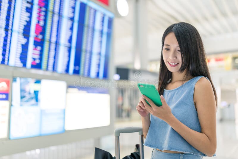 Woman Using Mobile Phone To Check Her Flight Schedule Stock Image ...