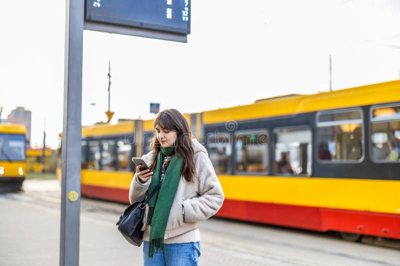 Woman Using Mobile Phone at the Tram Stop in the City Stock Image ...