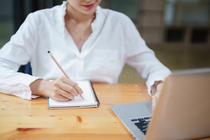 Woman Using a Notebook and Computer during a Video Conference Stock ...