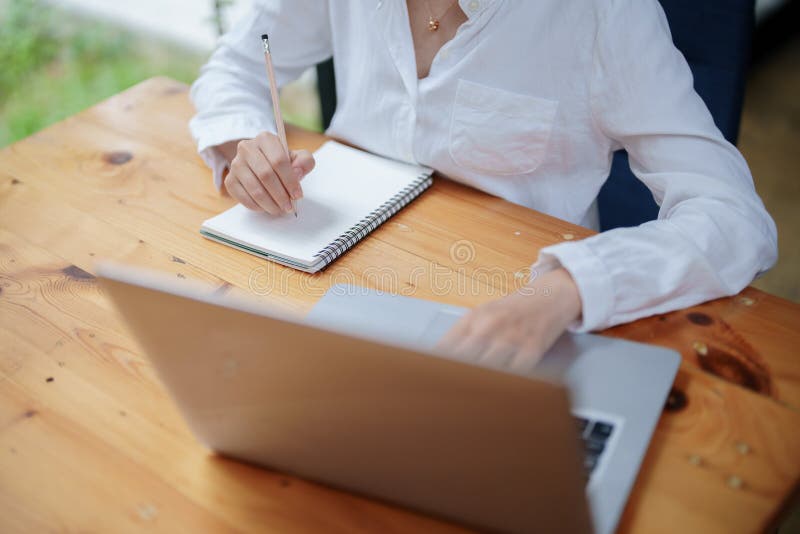 Woman Using a Notebook and Computer during a Video Conference Stock ...