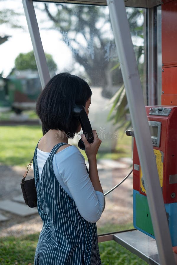 Woman Using Oldstyle Public Pay Phone in Telephone Booth Stock Image ...
