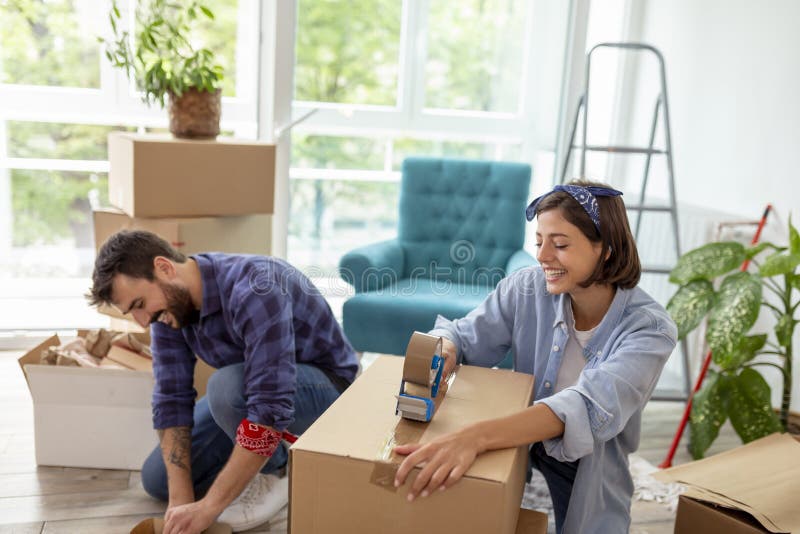 Taping Up Boxes stock photo. Image of beautiful, couple - 5343950