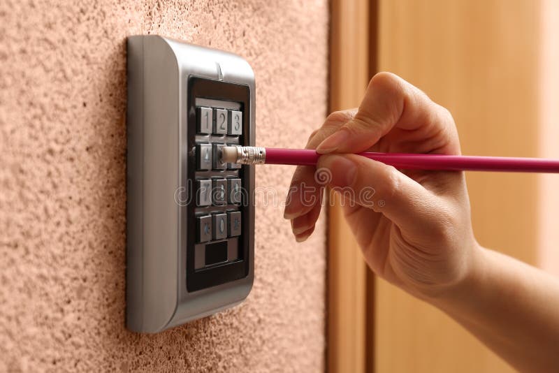 Woman Using Pencil To Enter Code on Electronic Lock`s Keypad, Closeup ...