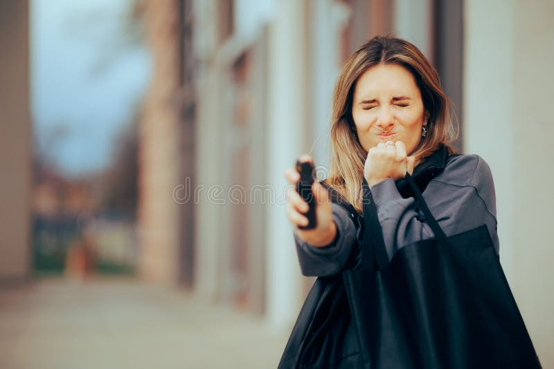 Woman Using A Pepper Spray Can For Self Defense On The Street Stock