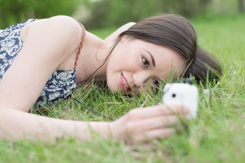 Woman using phone stock photo. Image of music, grass - 53937906