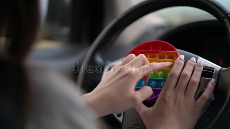 Woman Using Pop it or Simple Dimple in Car Stock Video - Video of press ...