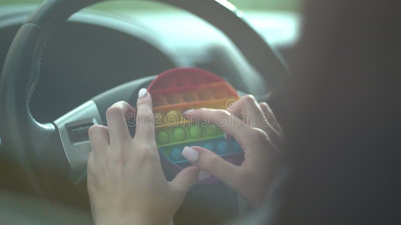 Woman Using Pop it or Simple Dimple in Car Stock Footage - Video of ...