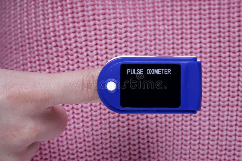 Woman Using Pulse Oximeter for Oxygen Level Testing. Stock Photo ...