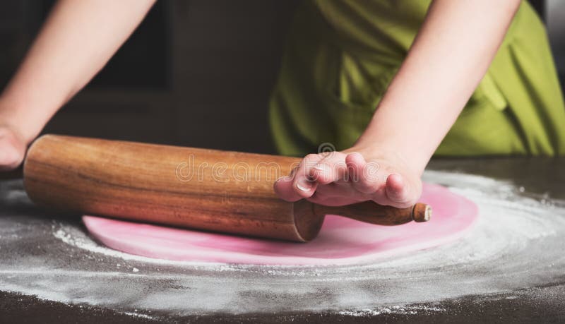 Woman Using Rolling Pin Preparing Pink Fondant for Cake Decorating ...