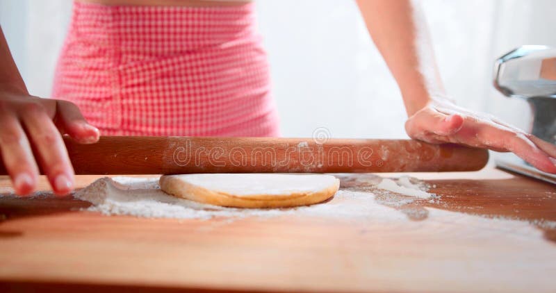 A Woman is Using a Rolling Pin Stock Image - Image of food, girl: 234119037