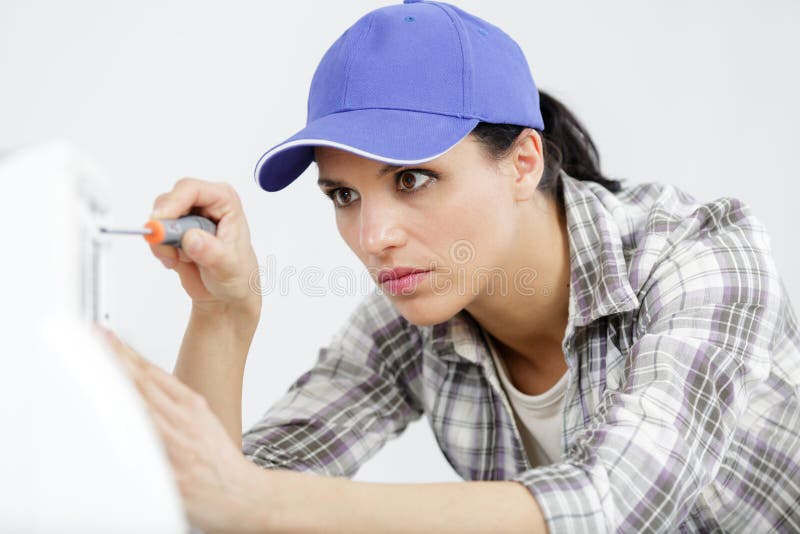 Woman Using Screwdriver To Repair Appliance Stock Photo - Image of ...