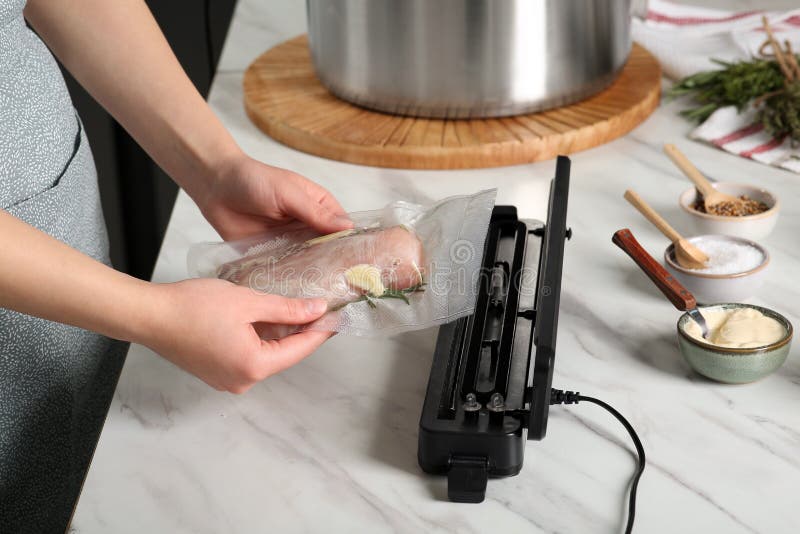 Woman Using Sealer for Vacuum Packing in Kitchen, Closeup. Sous Vide ...