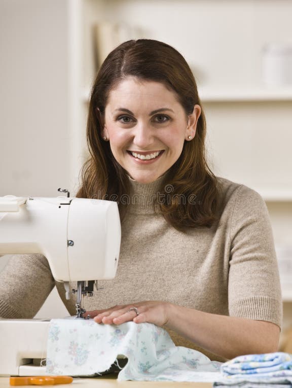 Woman Using Sewing Machine stock image. Image of house - 10320733