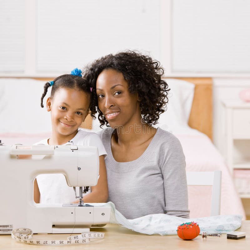 Woman Using Sewing Machine stock image. Image of house - 10320733