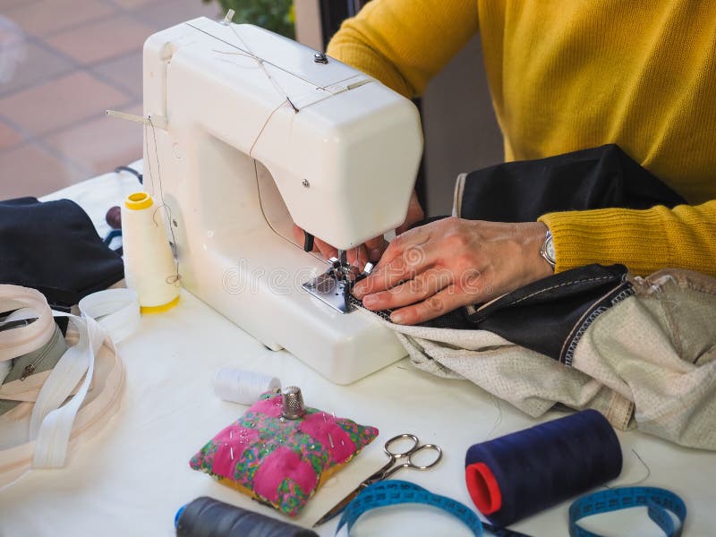 Woman Using Sewing Machine stock image. Image of business - 209228927