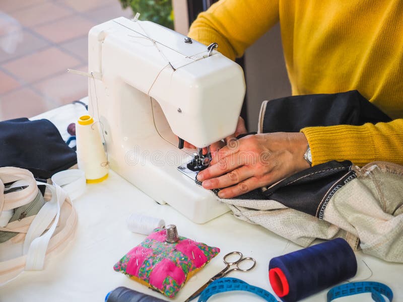 Woman Using Sewing Machine stock image. Image of dressmaking - 209228929